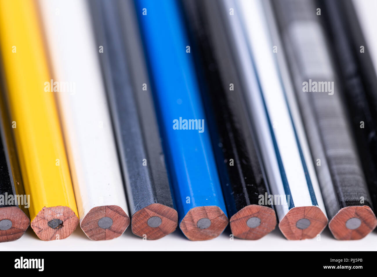 Several unsharpened new graphite pencils of different colors and ...