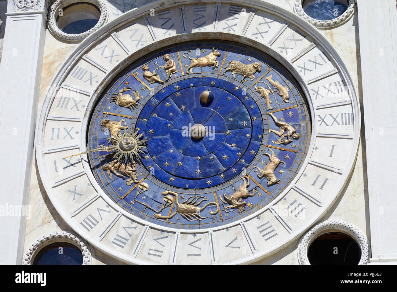 Saint Mark clock tower in Venice with gold zodiac signs in a sunny day ...