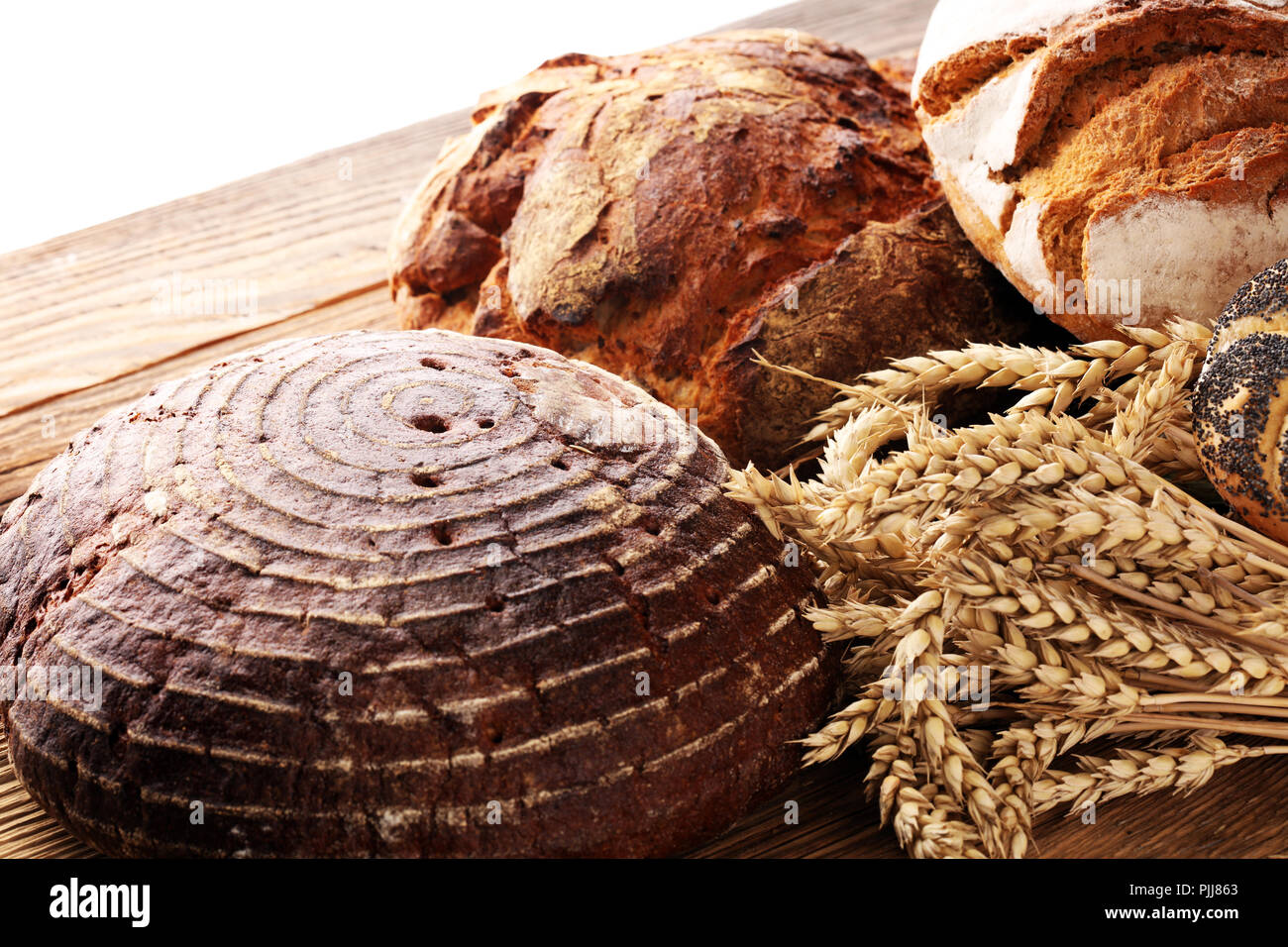 Different kinds of bread and bread rolls on board from above. Kitchen ...