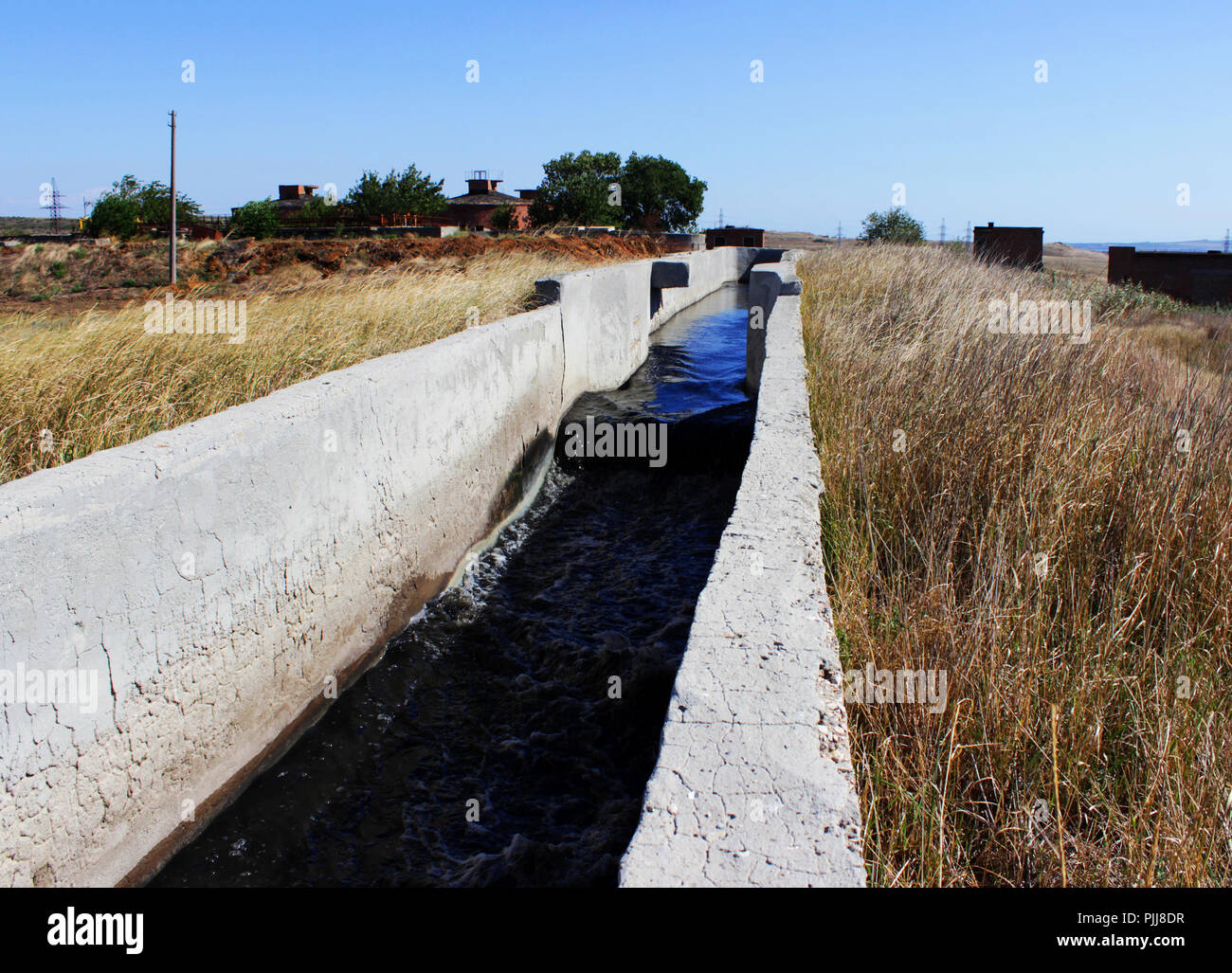 a cement ditch through which fluid flows through a treatment facilities ...