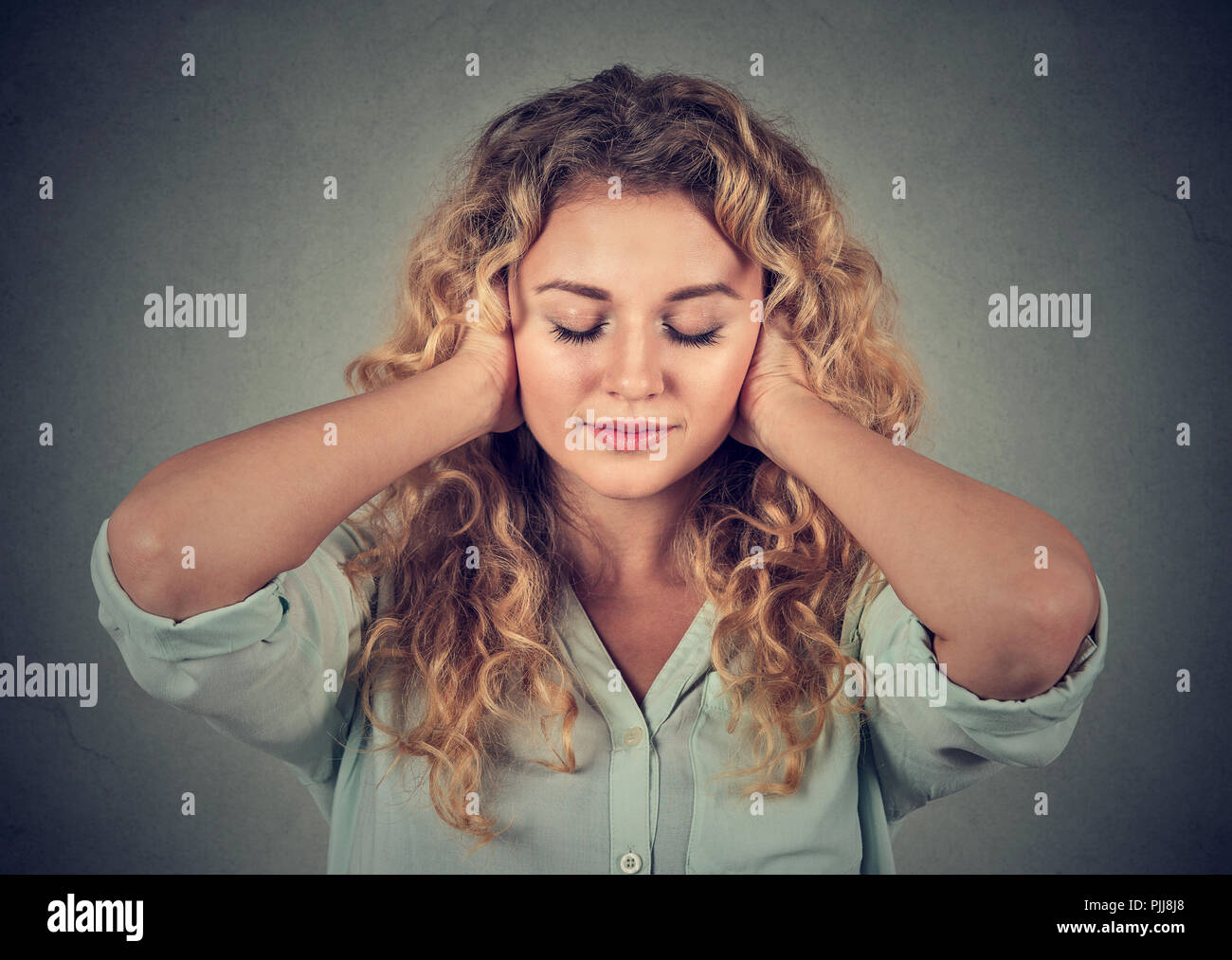 Woman covering ears noise hi-res stock photography and images - Alamy