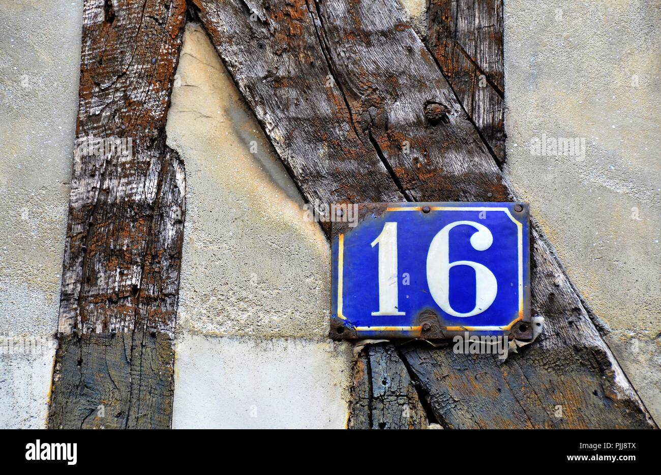 house number 16 on antique rustic wall, old, rusty enamel sign, white ...
