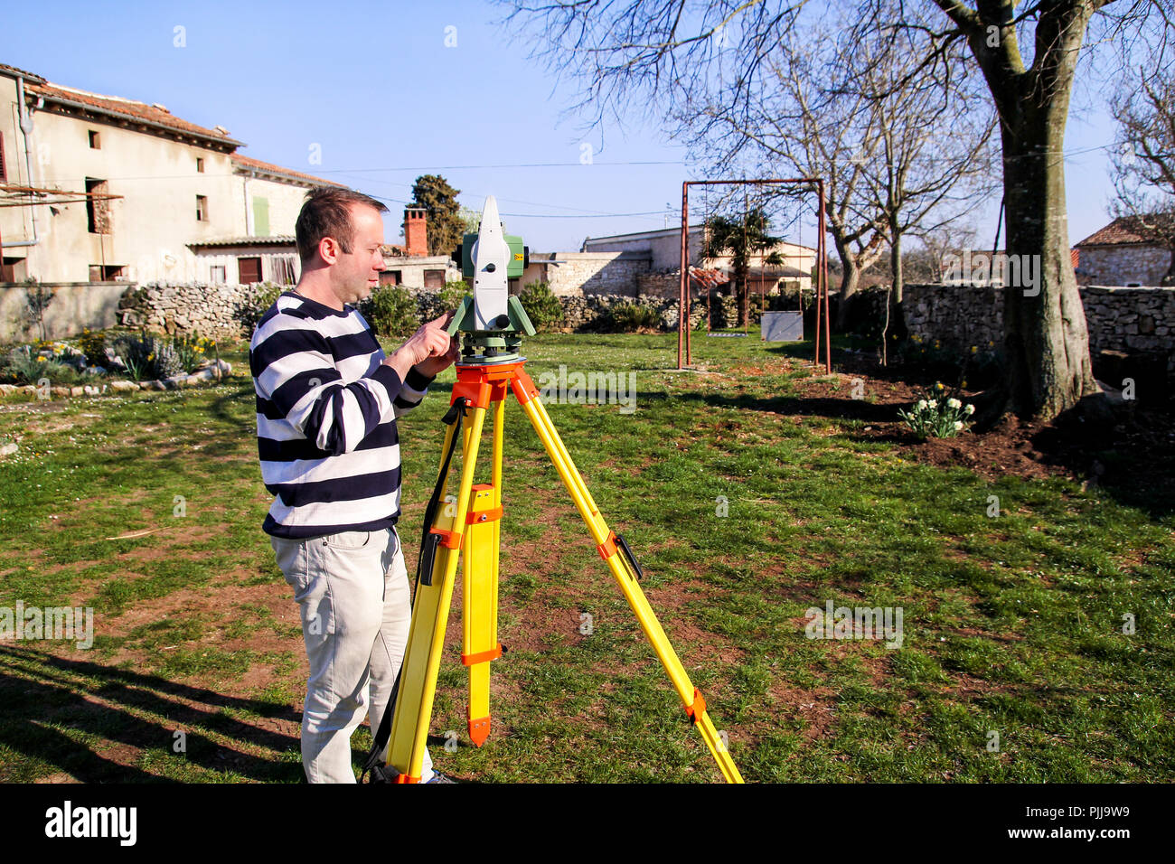 Man using of total station. Guy surveyor at work. Survey Instrument ...