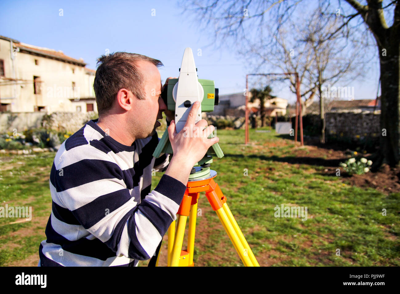 Man using of total station. Guy surveyor at work. Survey Instrument ...