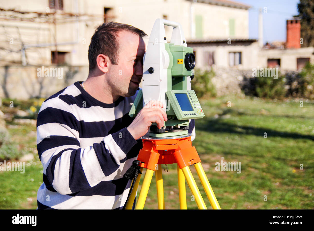 Man using of total station. Guy surveyor at work. Survey Instrument ...
