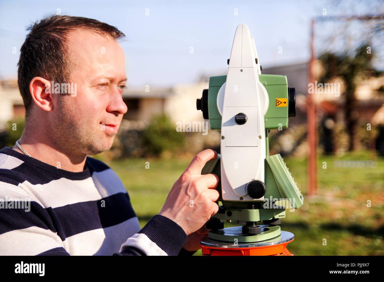 Man using of total station. Guy surveyor at work. Survey Instrument ...