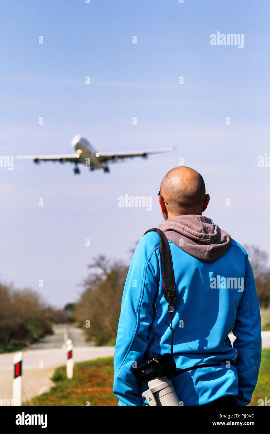 Man is spotting airplane. Spotting Airplane. Man is looking at the ...