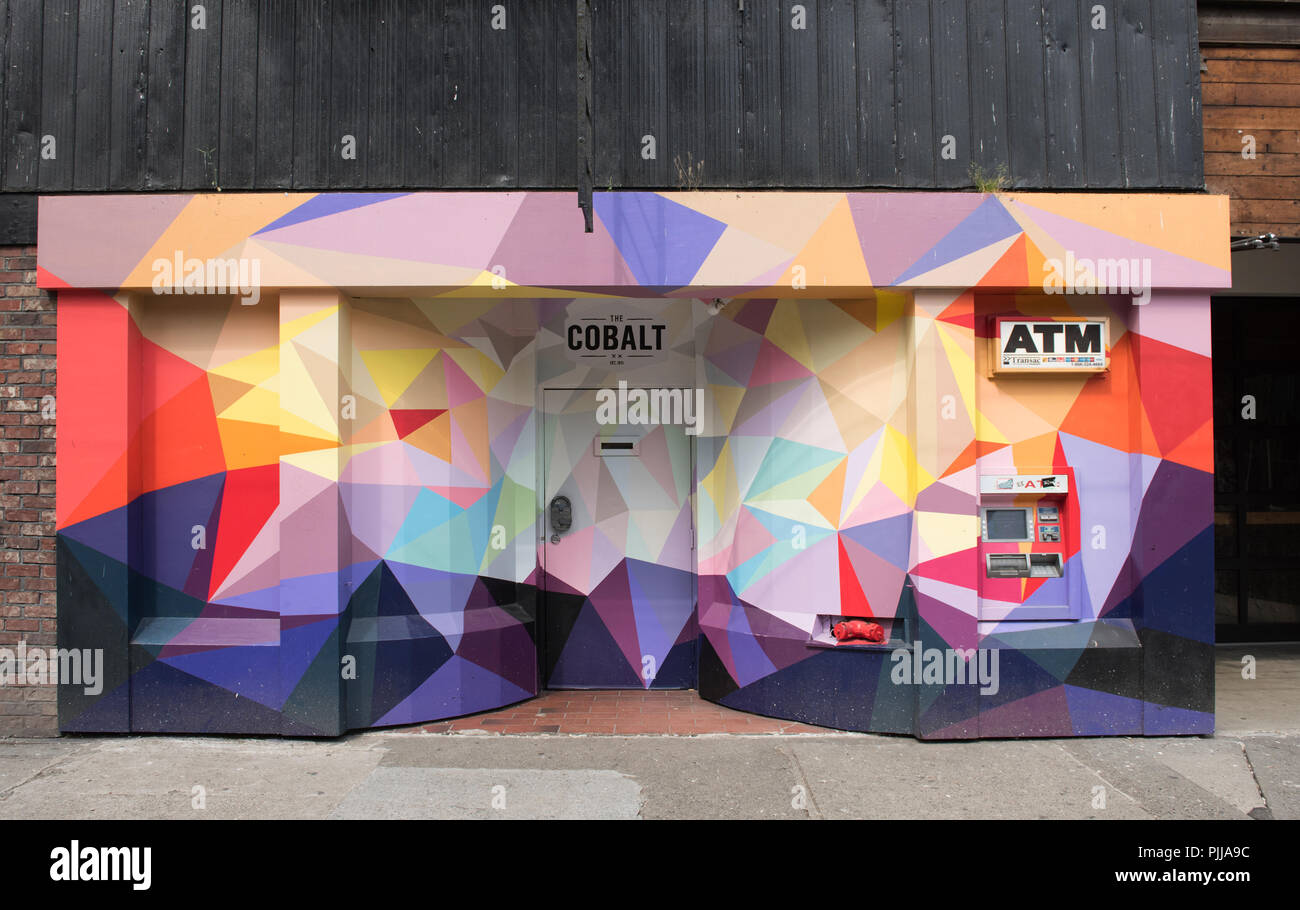Very colourful and brightly painted hotel entrance, and ATM machine ...