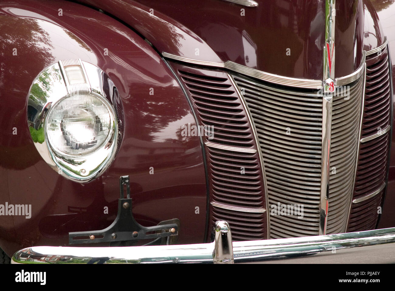 Close up of a classic vintage car chrome grill. Front end and head ...