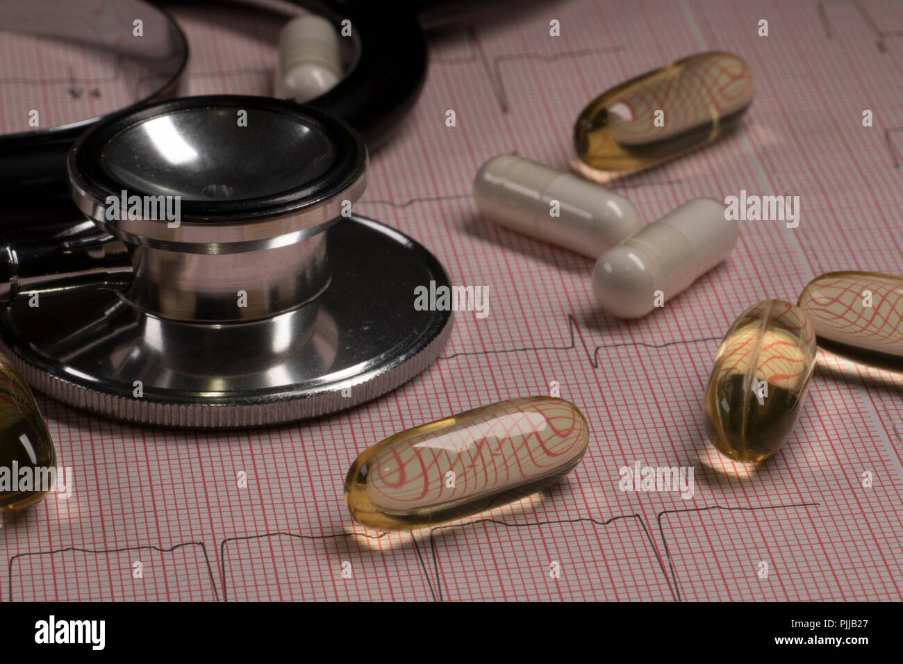 Cardiology heart chart with stethoscope and pills up close. Heart ...