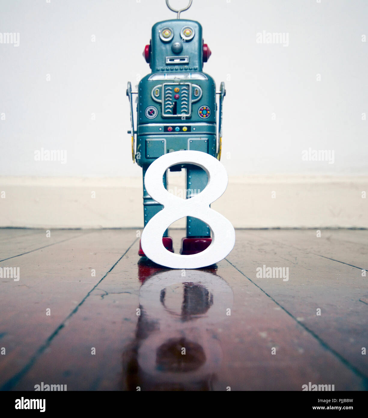 number 8 robot toy on a wooden floor with reflection Stock Photo - Alamy