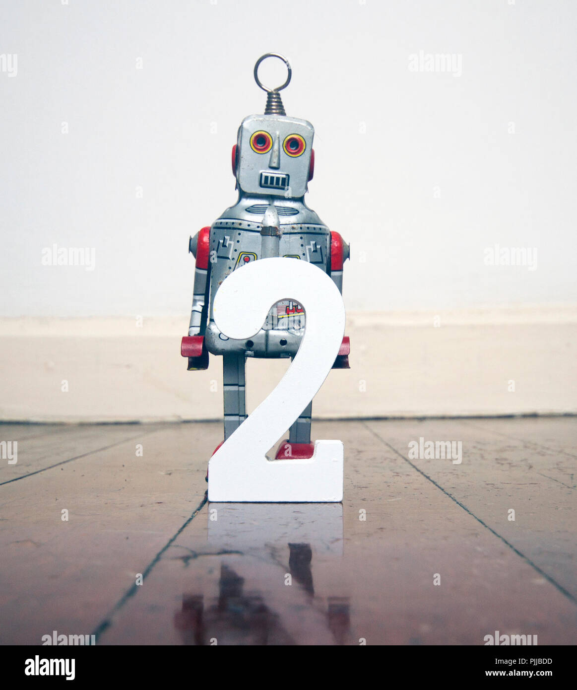number 2 robot on a wooden floor with reflection toned Stock Photo - Alamy