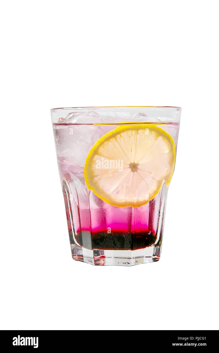 Transparent cocktail, refreshing water in a low glass with ice cubes, berry, fruit syrup and a ...