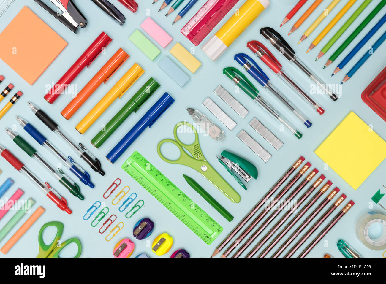 Neatly arranged stationery items on a blue background Stock Photo - Alamy