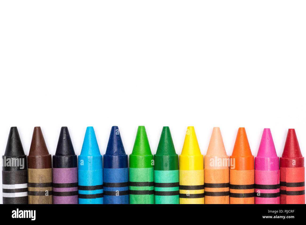 Neat row of colored crayons on white background Stock Photo - Alamy