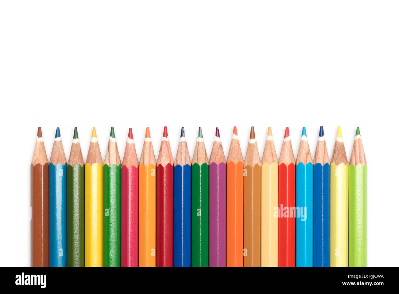 Colouring pencil row. randomly arranged crayons in a line on white ...