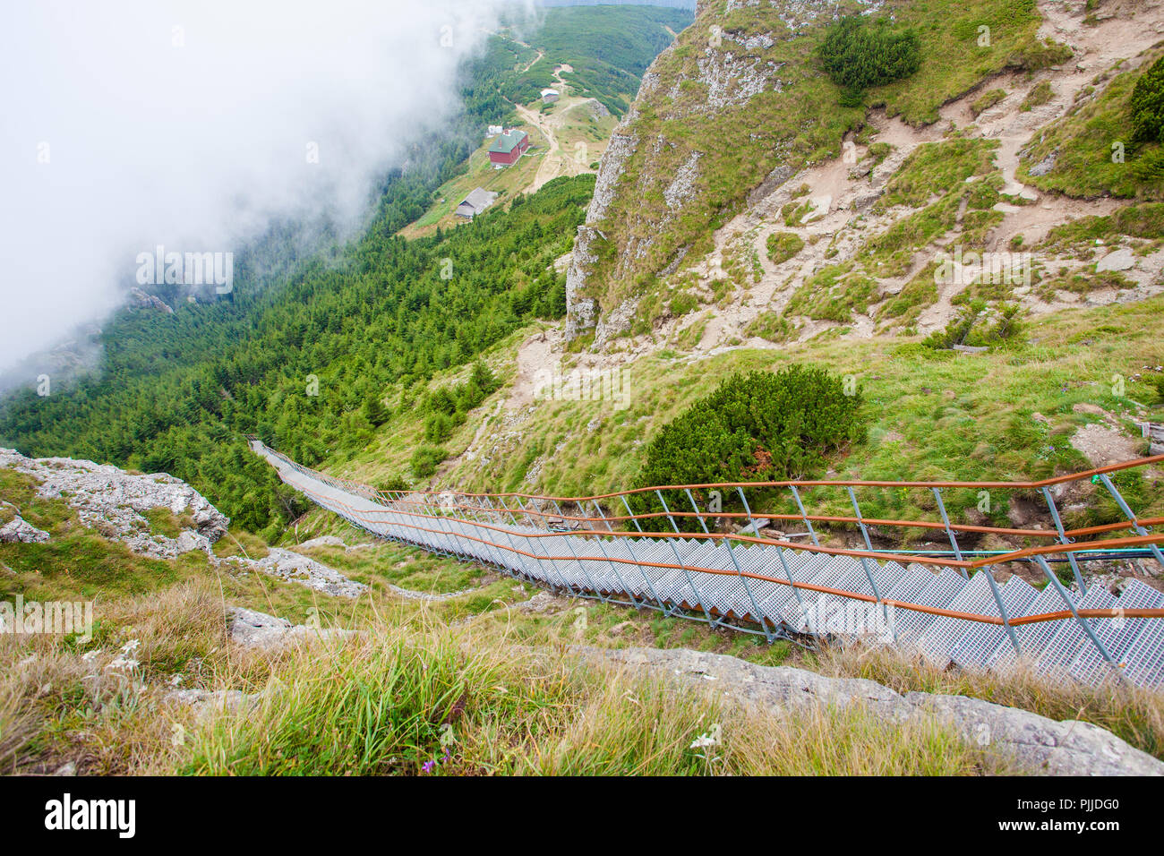 ladder with stairs in the beautiful mountain landscape. Ceahlau, Toaca ...