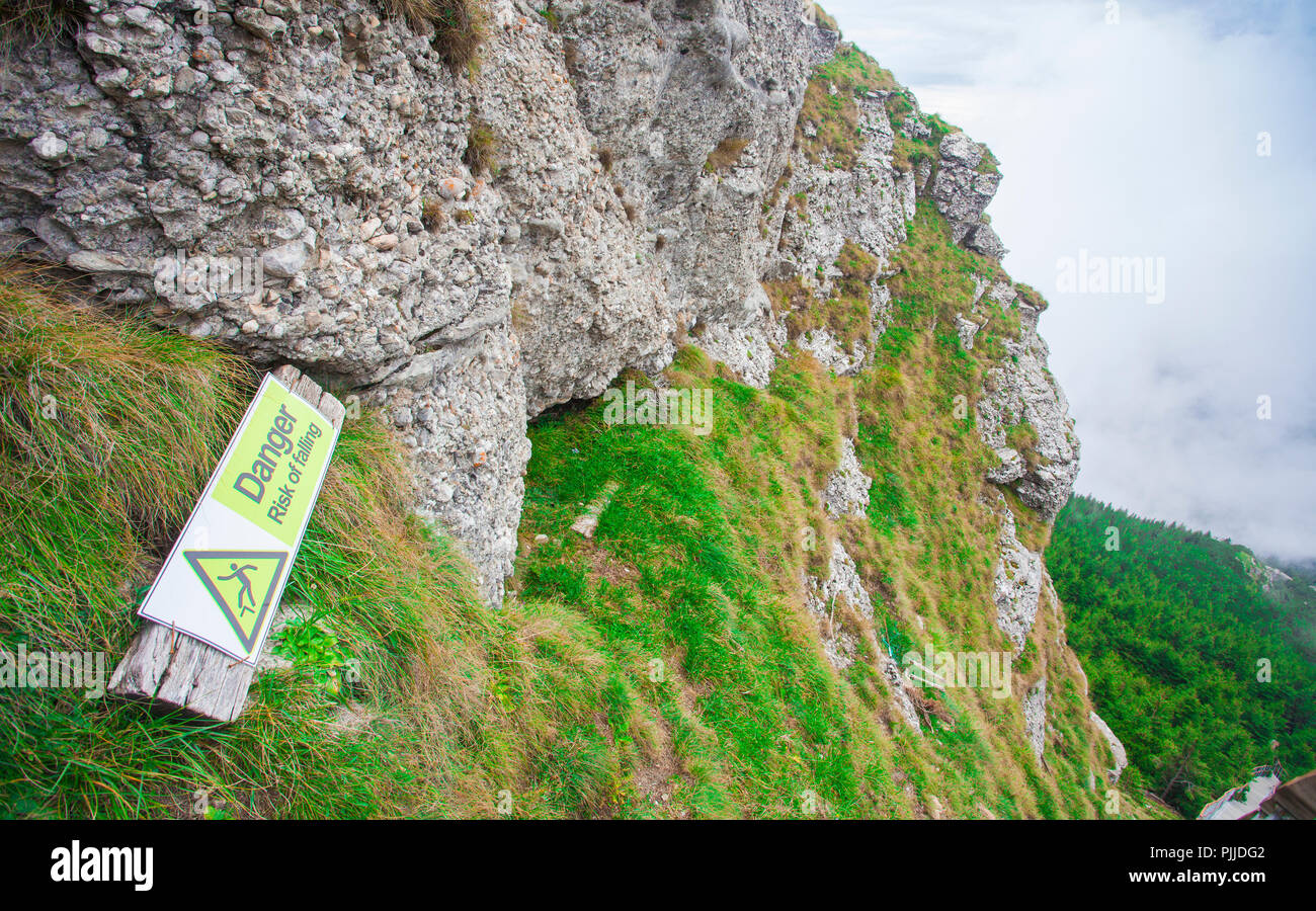 danger risk of falling sign on mountain landscape Stock Photo - Alamy