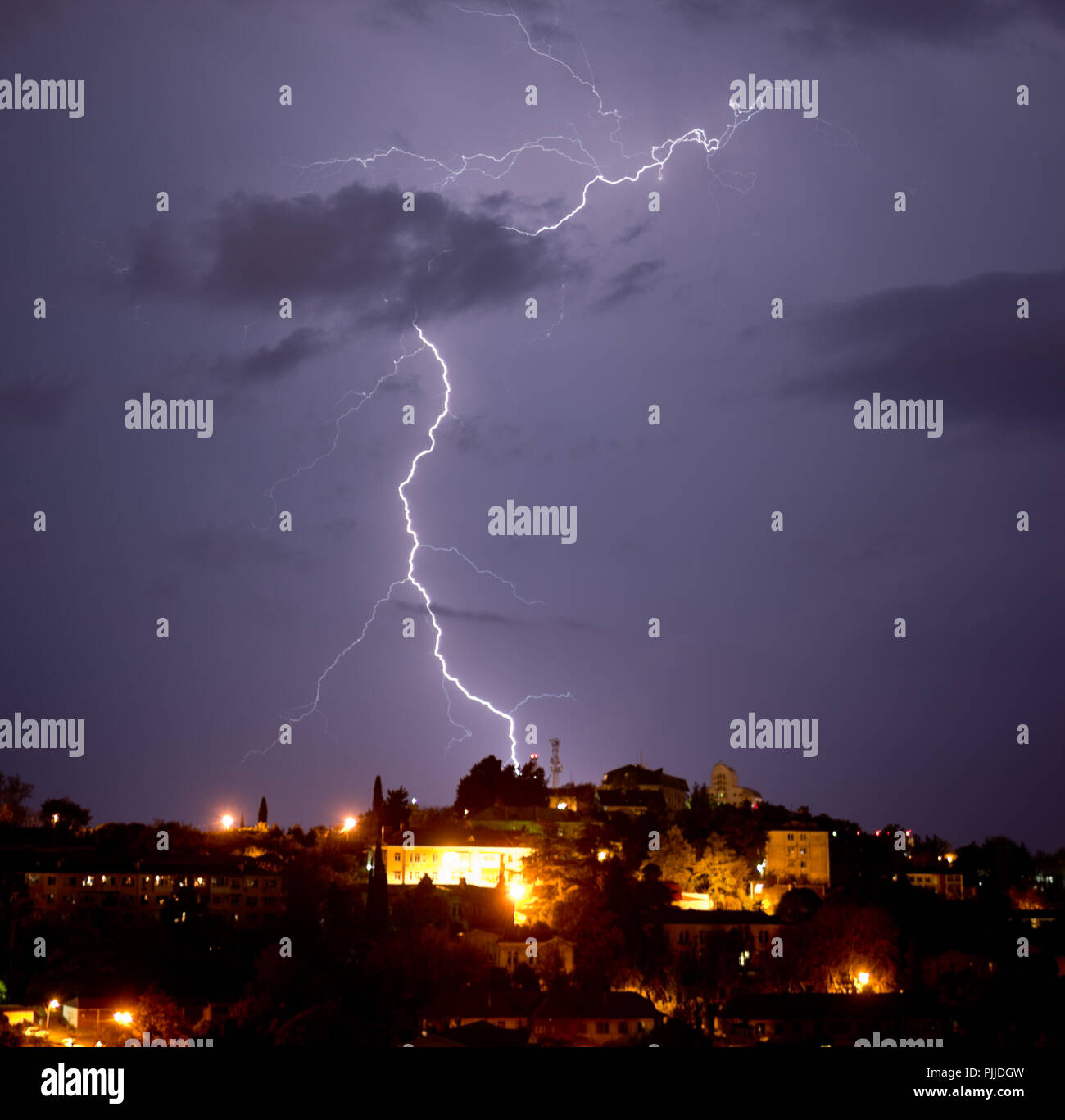 Lightning strike over city Stock Photo - Alamy