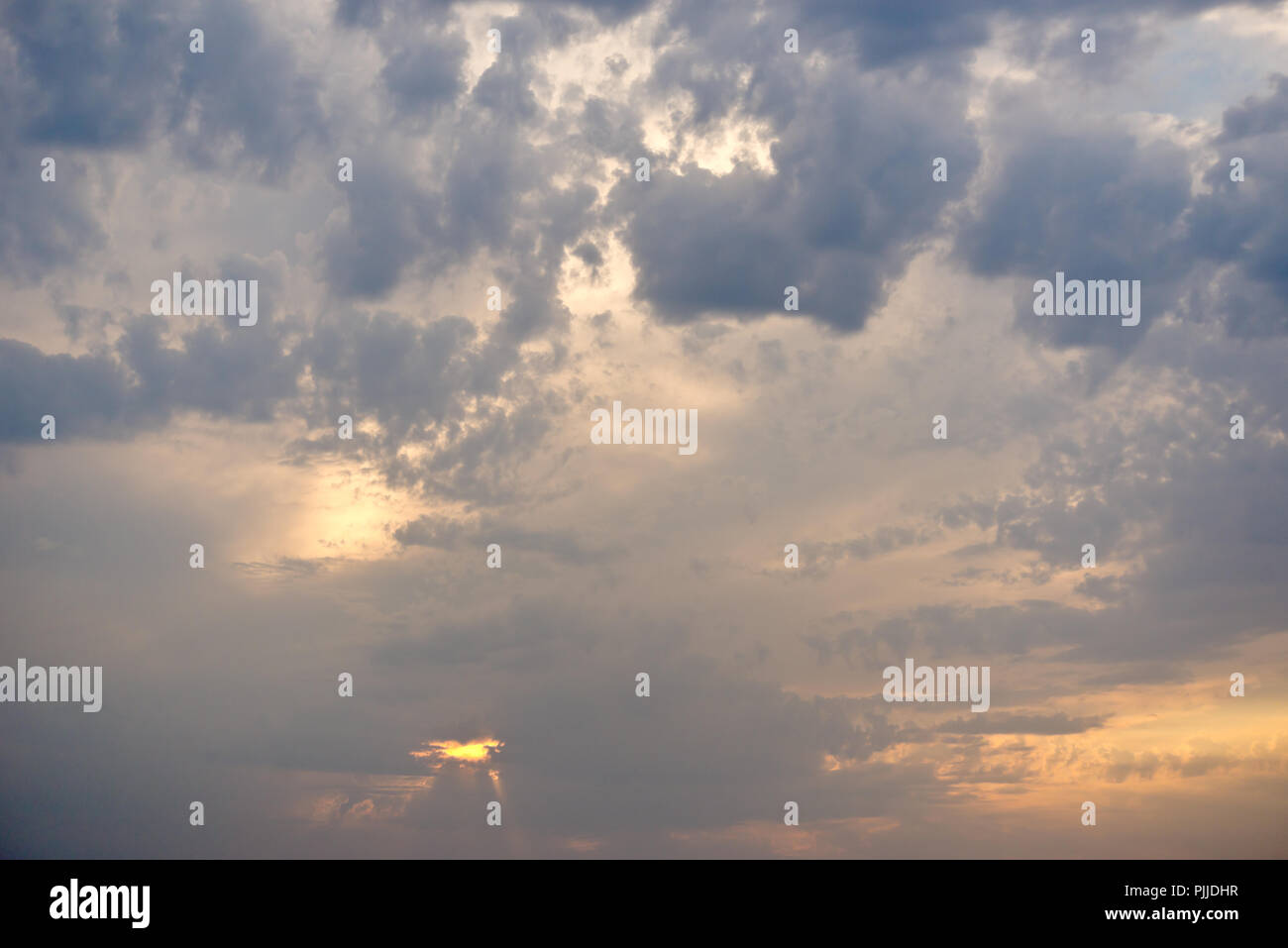 Sunset sky with blue clouds Stock Photo - Alamy