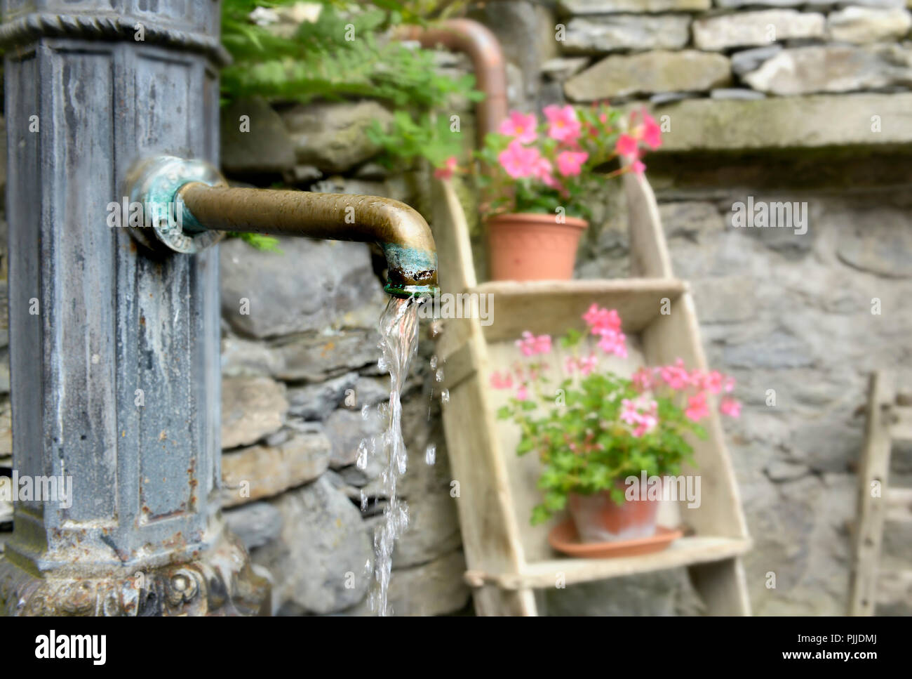water flowing from a fountain in a village Stock Photo - Alamy