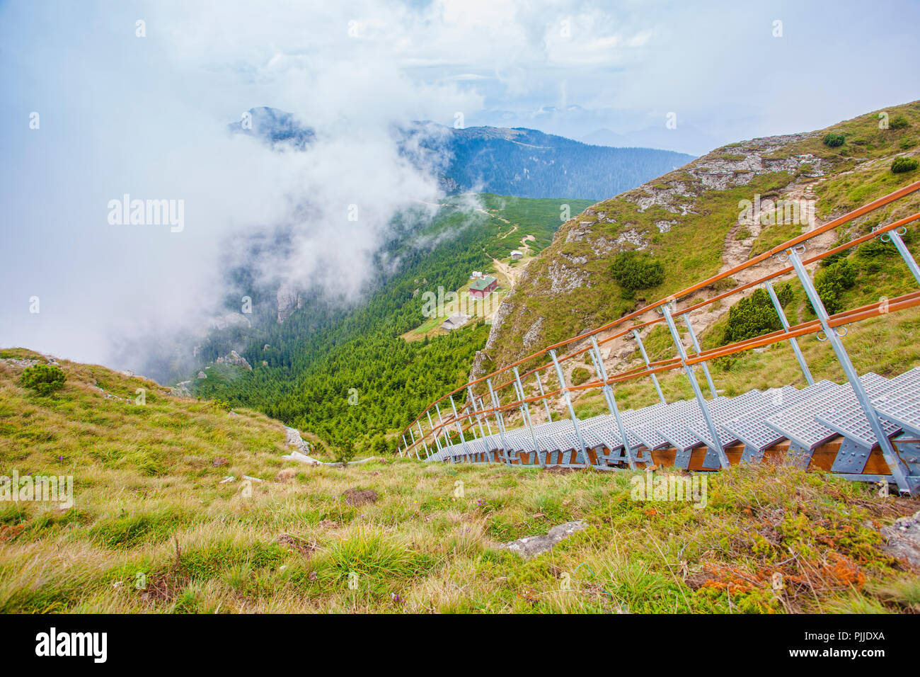 ladder with stairs in the beautiful mountain landscape. Ceahlau, Toaca ...
