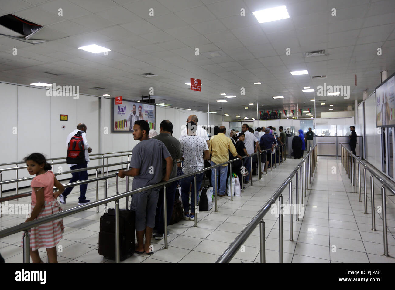 Tripoli, Libya. 7th Sep, 2018. Passengers check in their flights at the ...