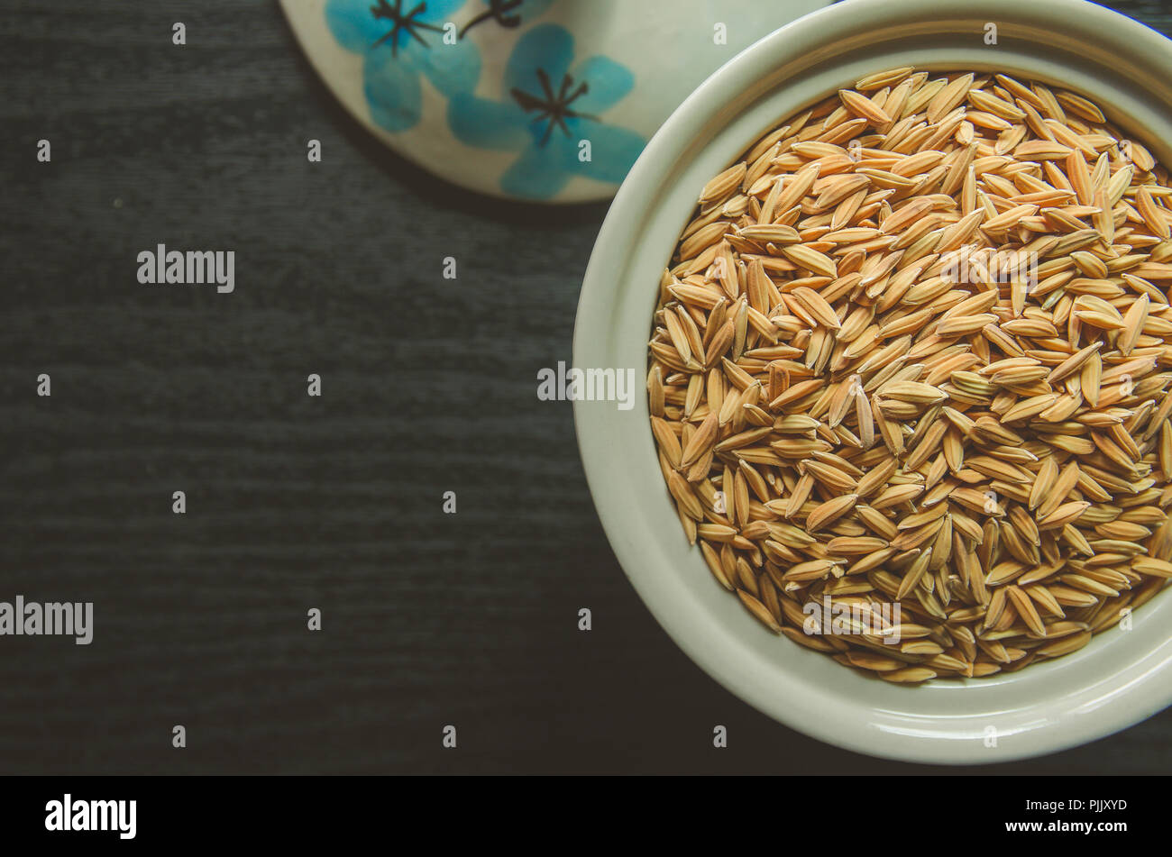 Top view of paddy rice and rice seed on dark wooden floor, Background ...