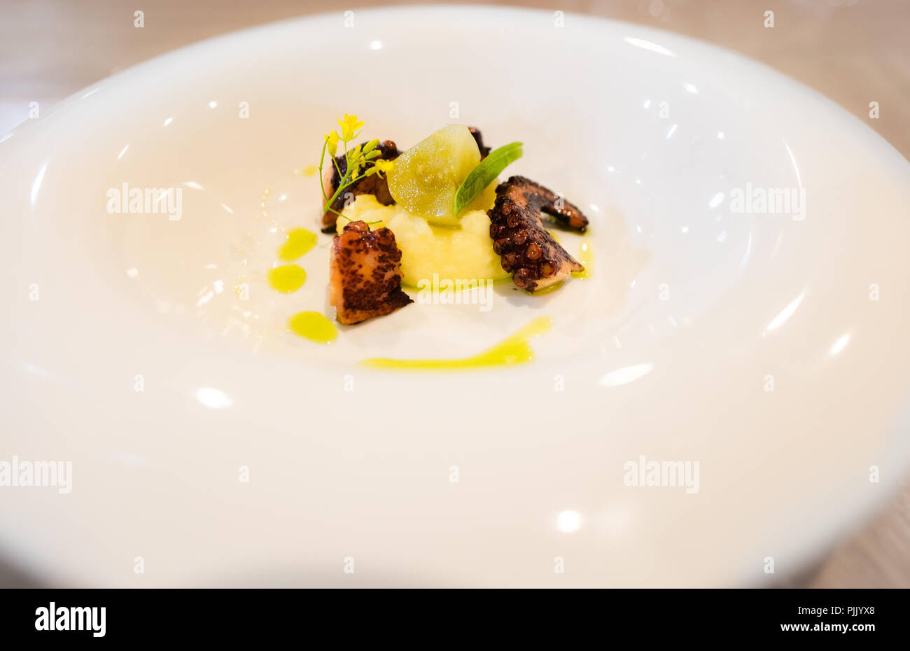 Roasted Octopus accompanied by Pickled Tomatoes, Potato Puree, and Fig ...