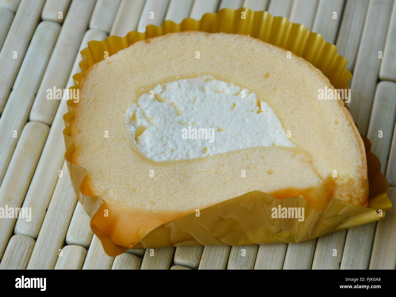 vanilla roll cake with fresh cream on bamboo plate Stock Photo - Alamy
