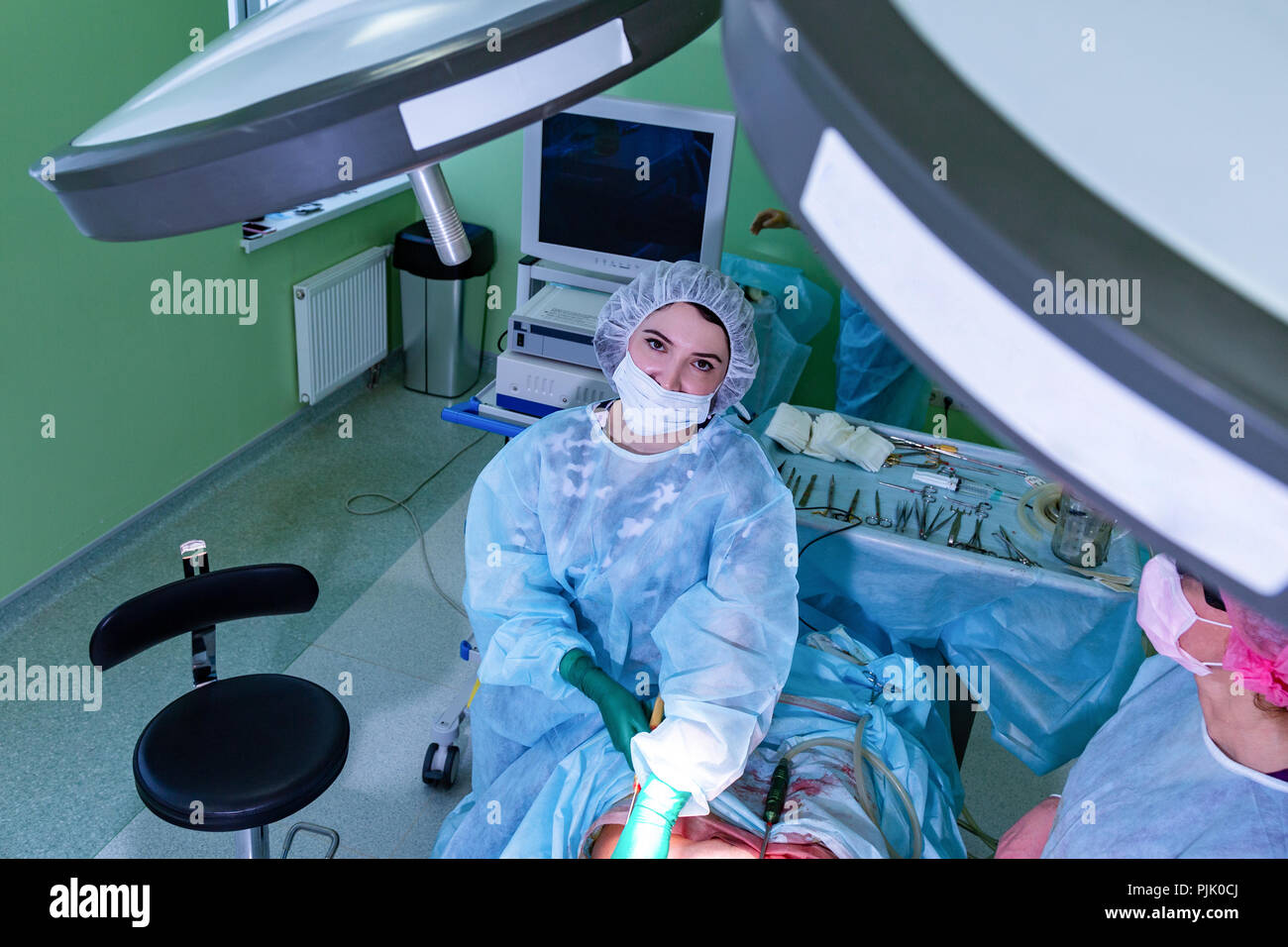 cosmetic liposuction surgery in actual operating room, group of ...