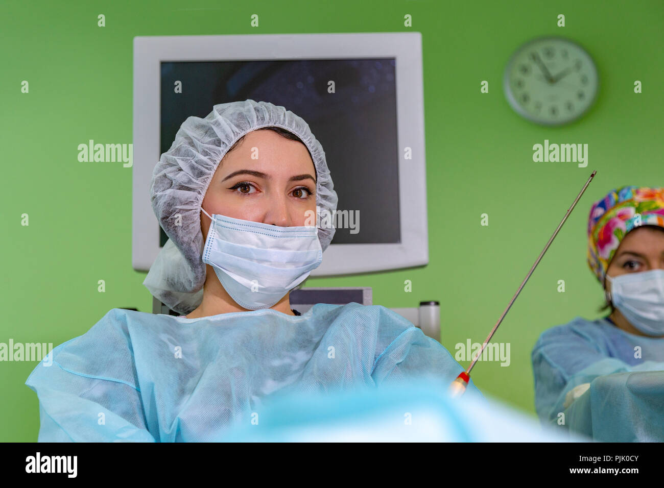 cosmetic liposuction surgery in actual operating room, group of ...