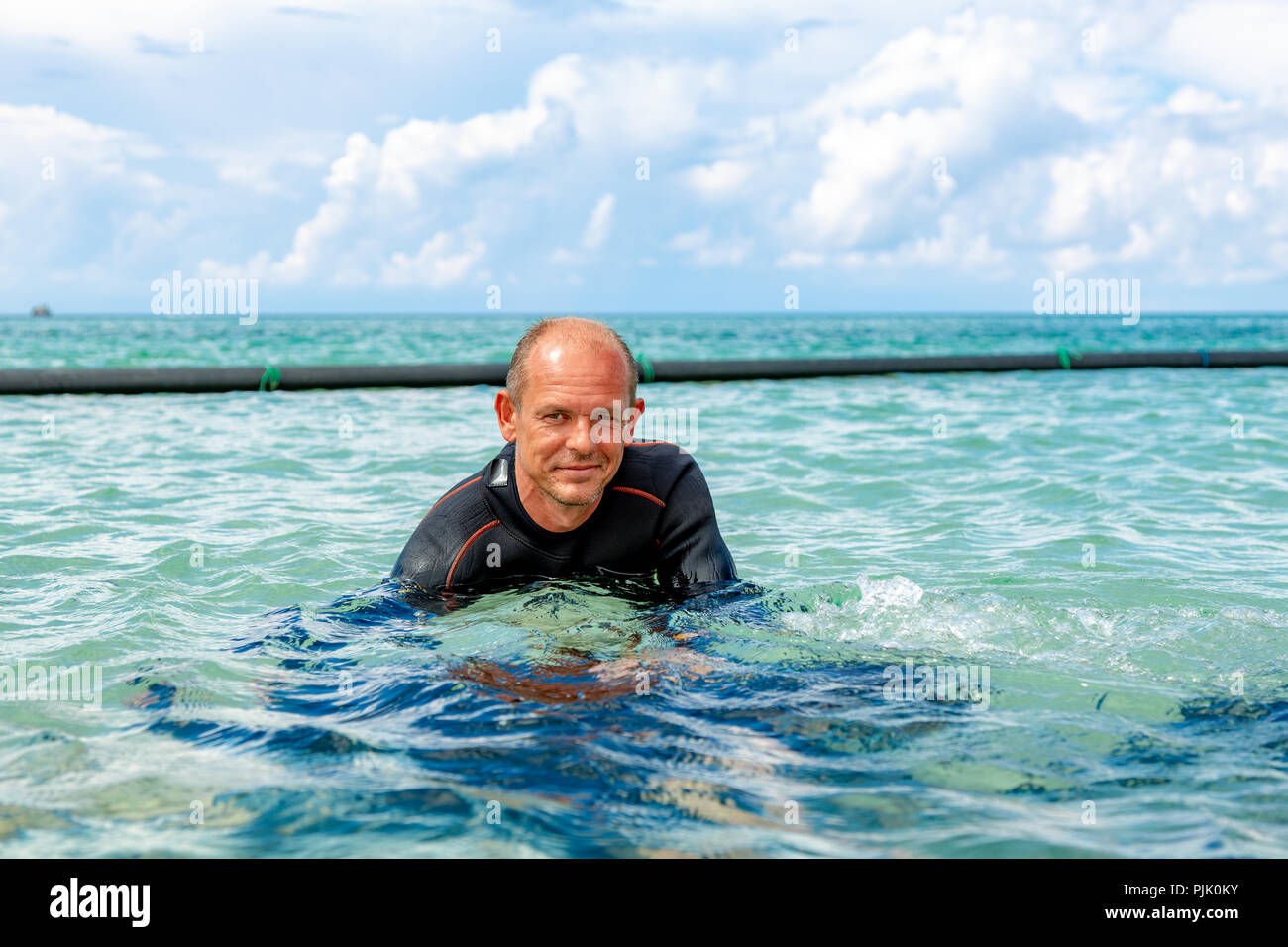 Scuba diverin a suit for diving prepares to dive Stock Photo - Alamy