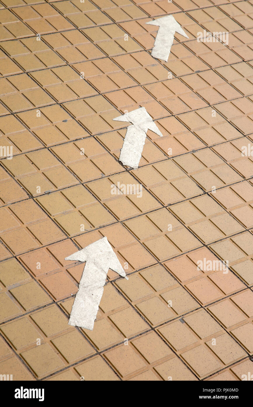 Arrow Sign on Pavement with Diagonal Slant Stock Photo - Alamy