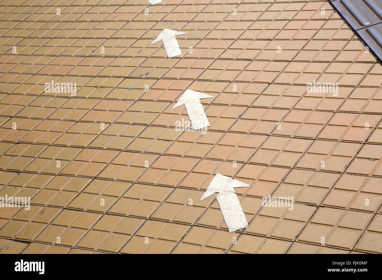 Arrow Sign on Pavement with Diagonal Slant Stock Photo - Alamy