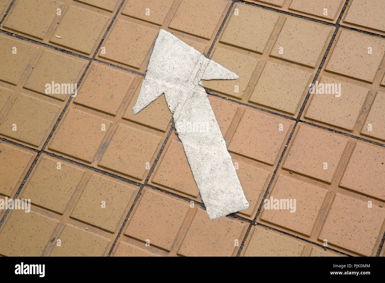 Arrow Sign on Pavement with Diagonal Slant Stock Photo - Alamy