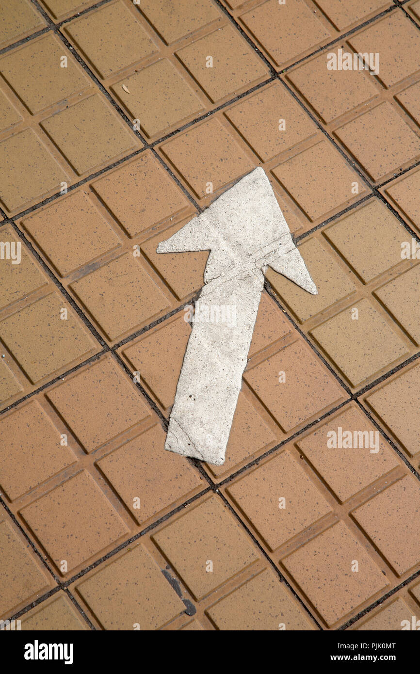 Arrow Sign on Pavement with Diagonal Slant Stock Photo - Alamy