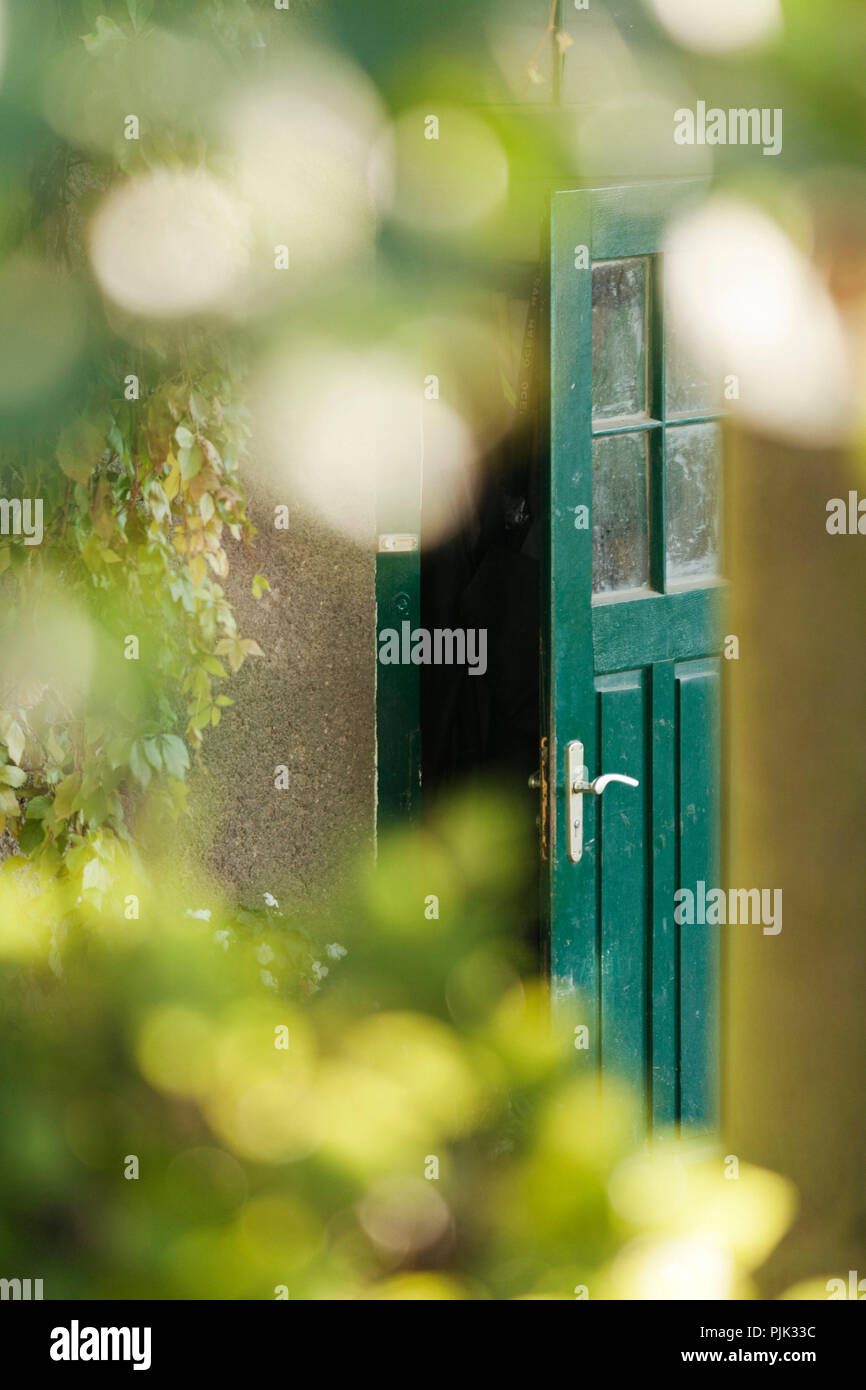 Door to a house, hidden by trees Stock Photo - Alamy