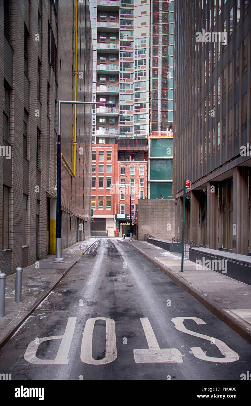 Street canyon and skyscrapers in the Financial District of Manhattan ...
