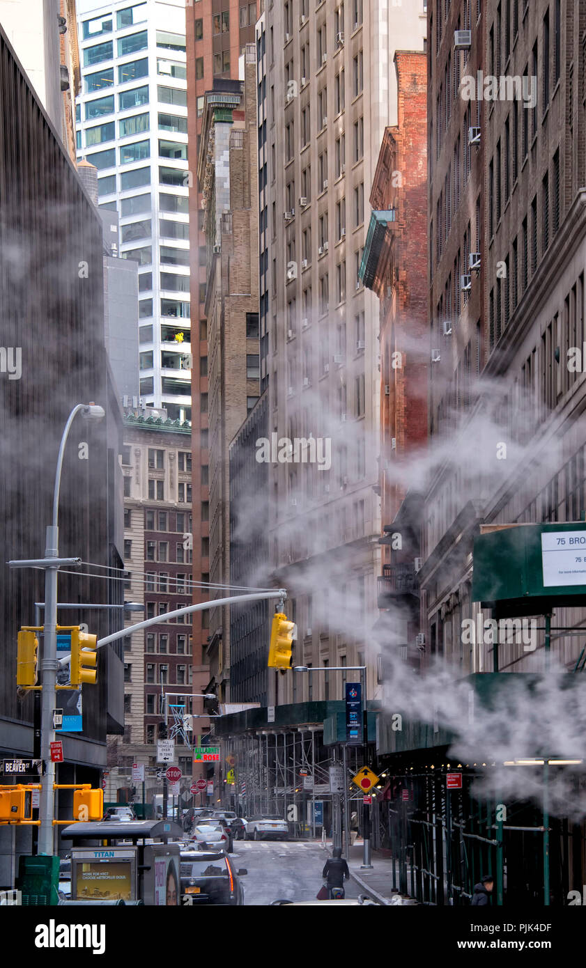 Street canyon with steam and skyscrapers in the Financial District in ...
