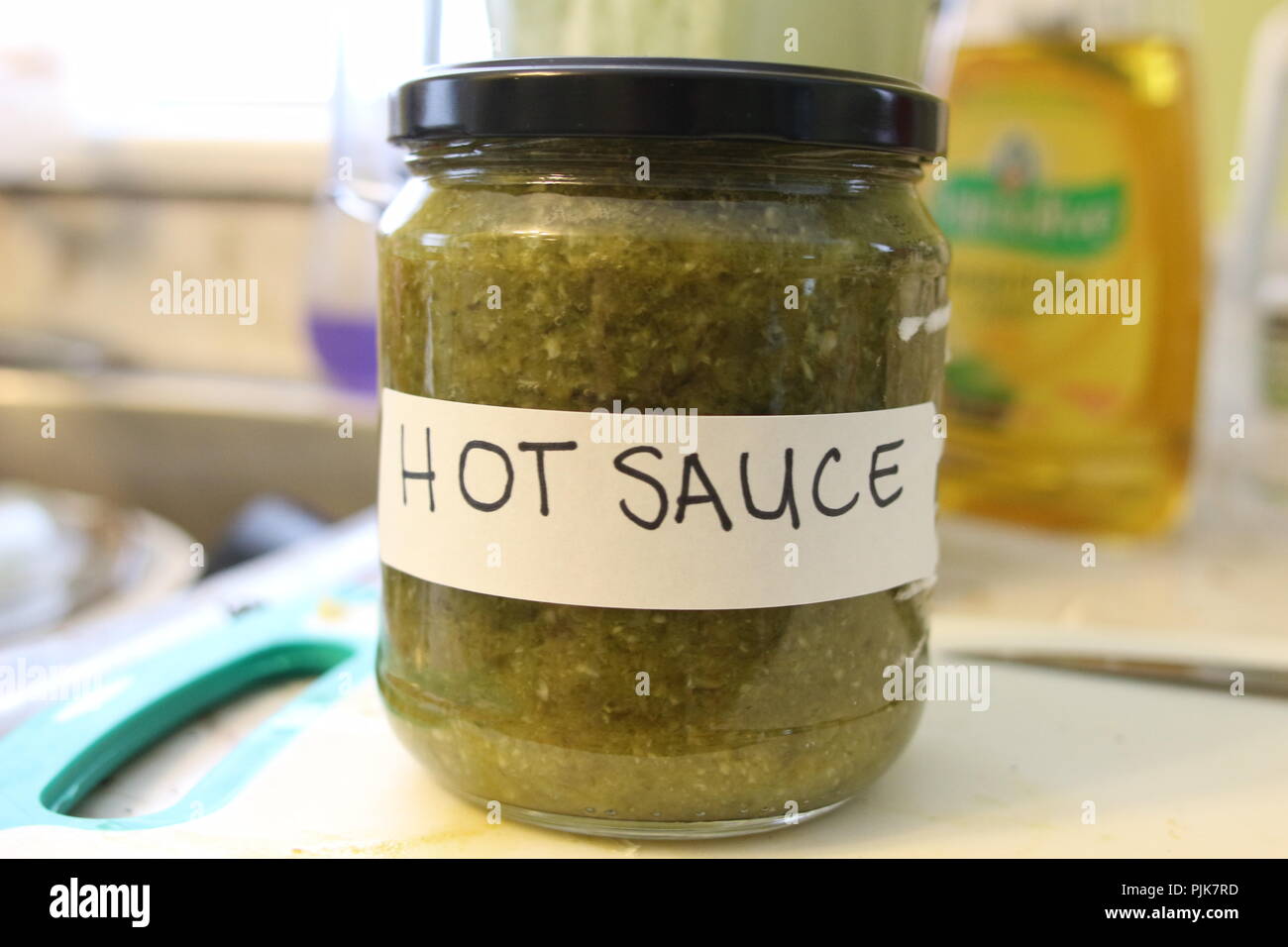 Homemade green hot sauce with a label on it Stock Photo - Alamy