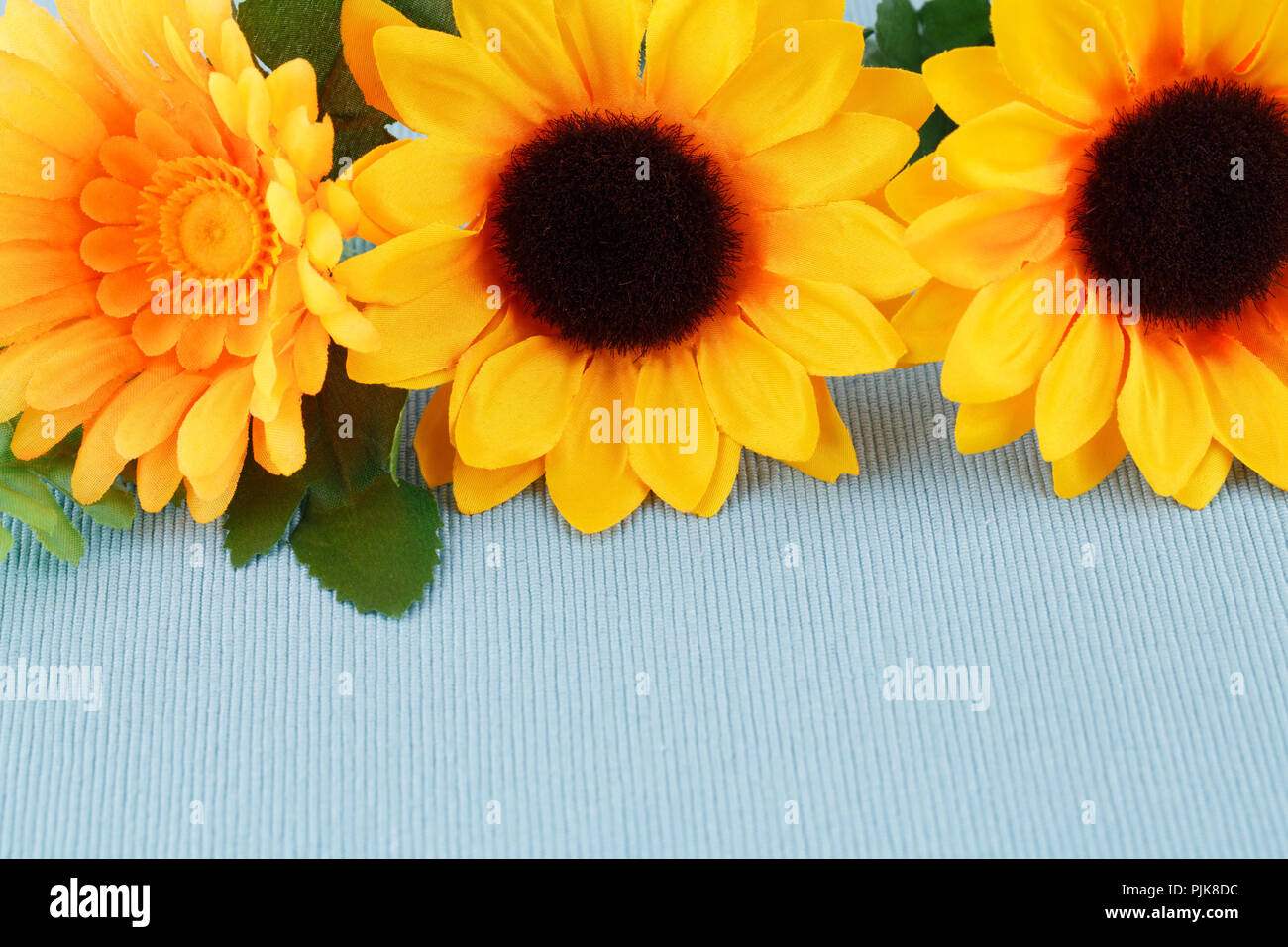 Yellow fabric flowers on cloth background, closeup picture Stock Photo ...