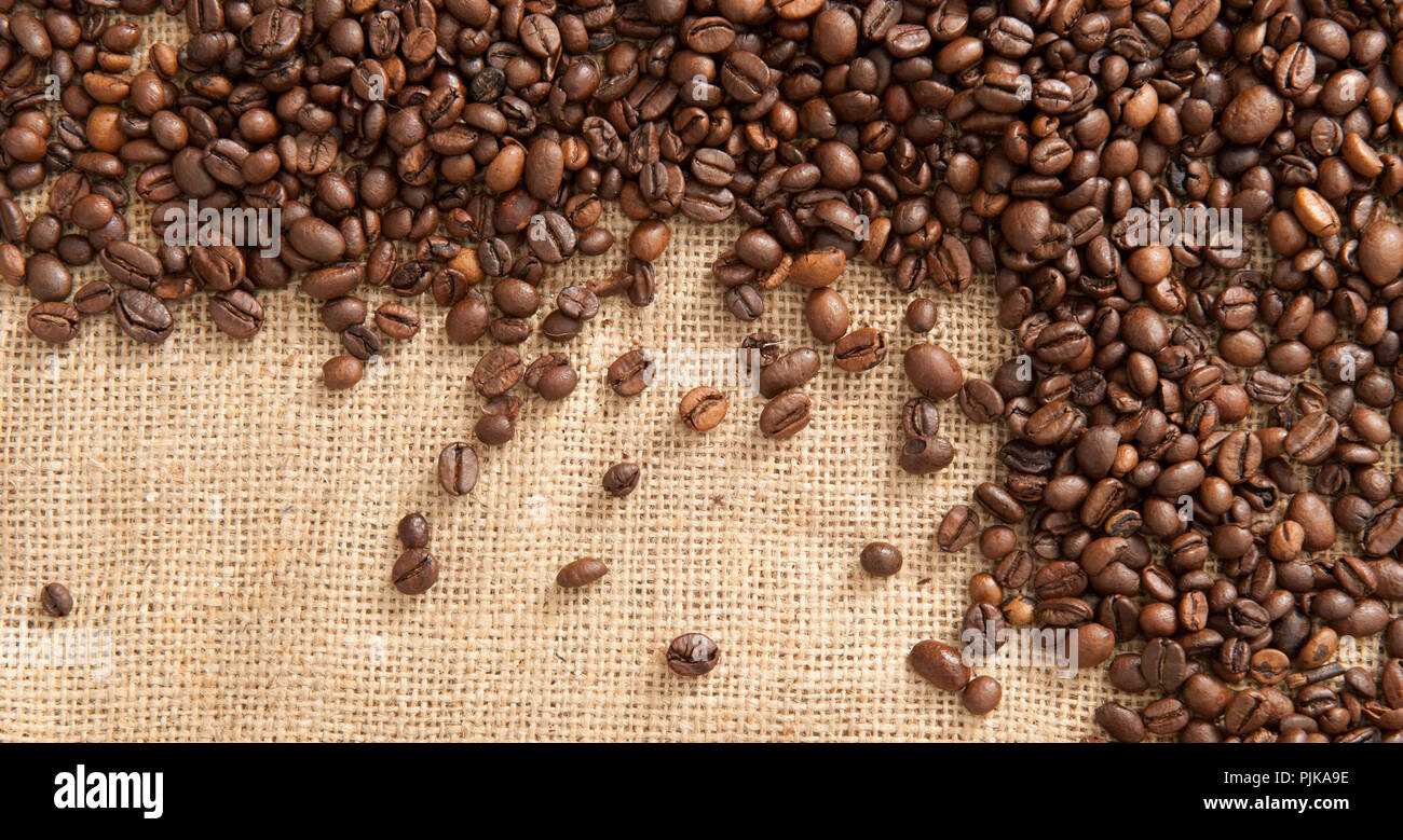Background with coffee beans on the background of sacking Stock Photo ...