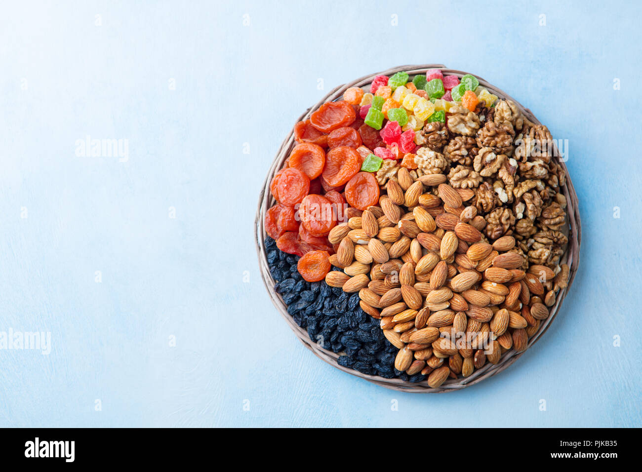 Assortment of nuts and dry fruits. Healthy food. Blue background. Top ...
