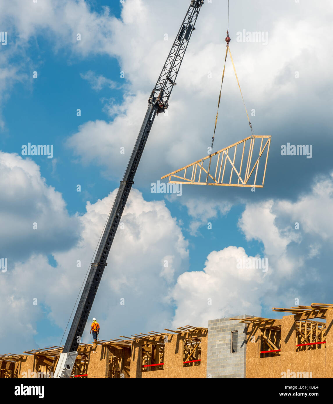 Crane lifting wood truss roof hi-res stock photography and images - Alamy
