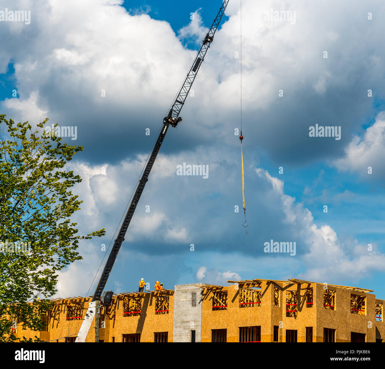 Crane lifting wood truss roof hi-res stock photography and images - Alamy