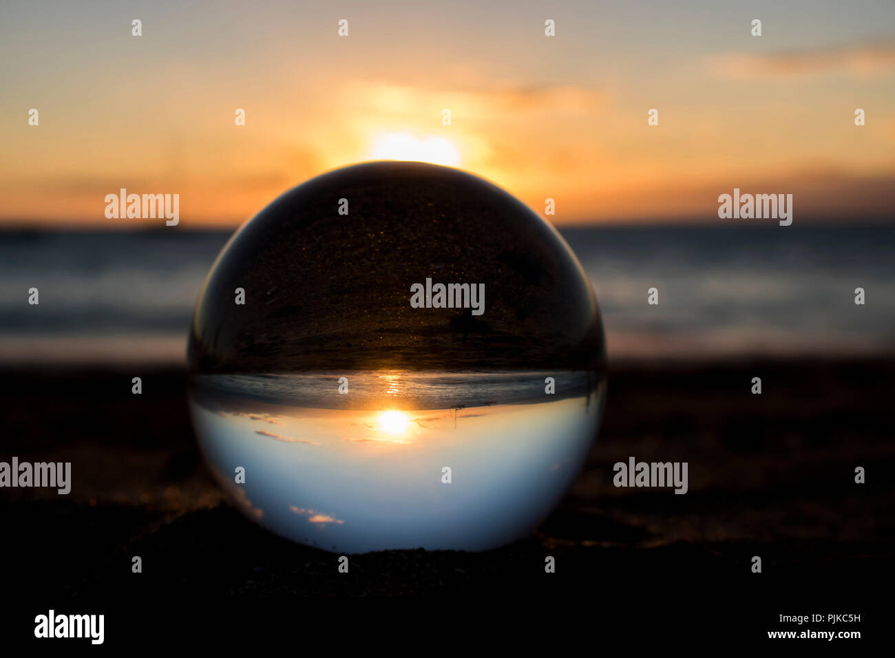 Sunset with Sand and Sea Taken Through Glass or Crystal Ball Stock ...
