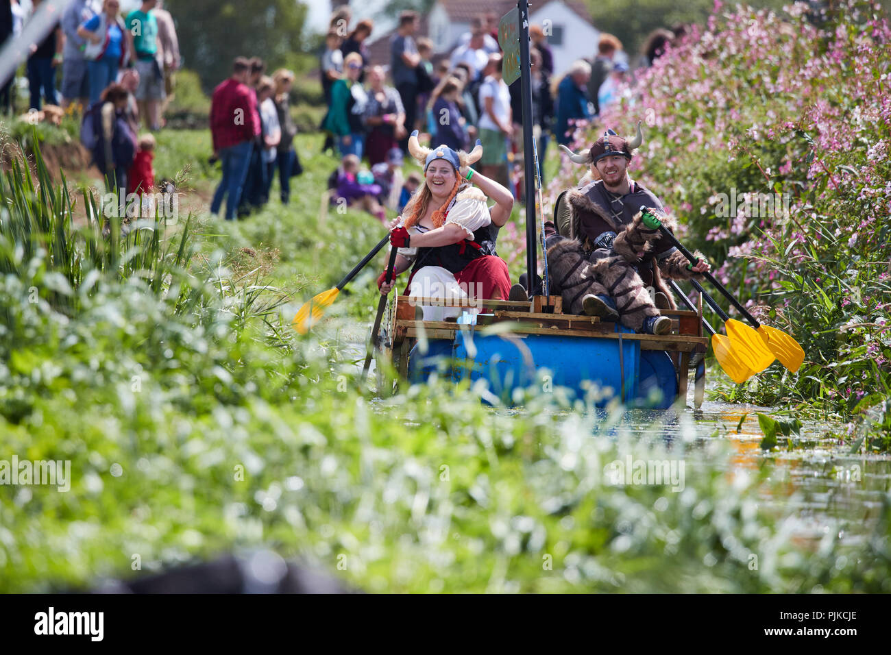People in viking costumes rowing a raft along a river at The Lowland ...