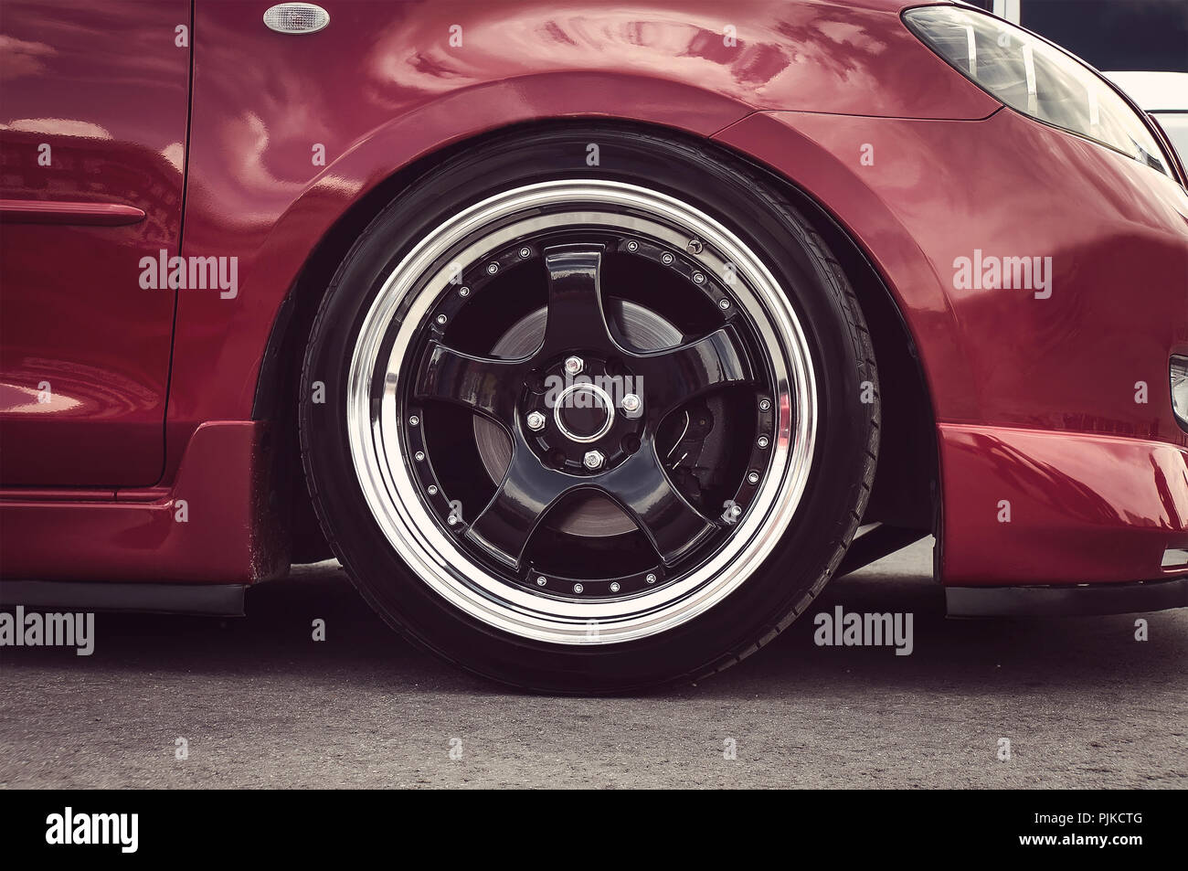 Car wheel in summer. Tuning wheel with the new drive the red car Stock ...