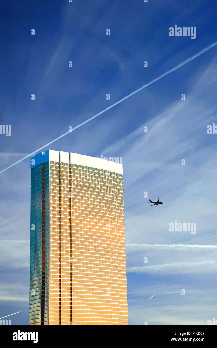 A high rise luxury hotel rising into a blue sky Stock Photo - Alamy